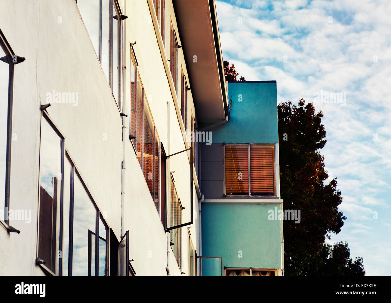 Apartment building wall with windows open, summer day with sunshine ...