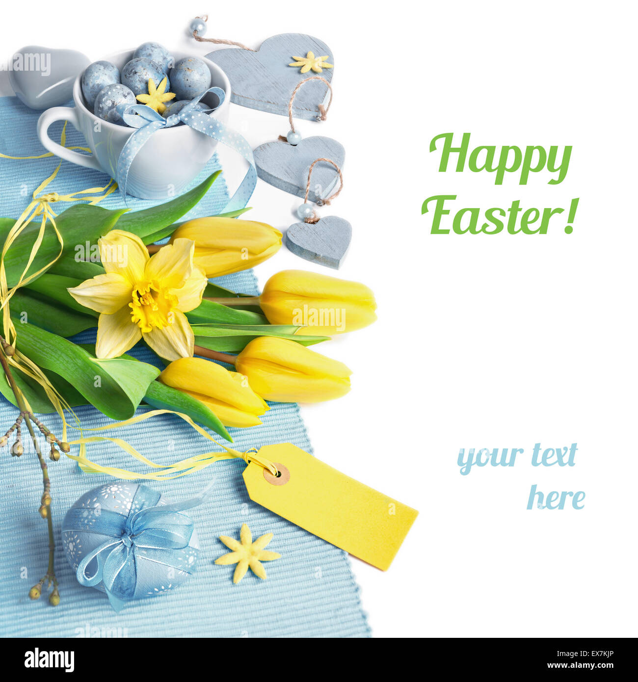 Easter border with yellow tulips and pale blue spring decorations ...