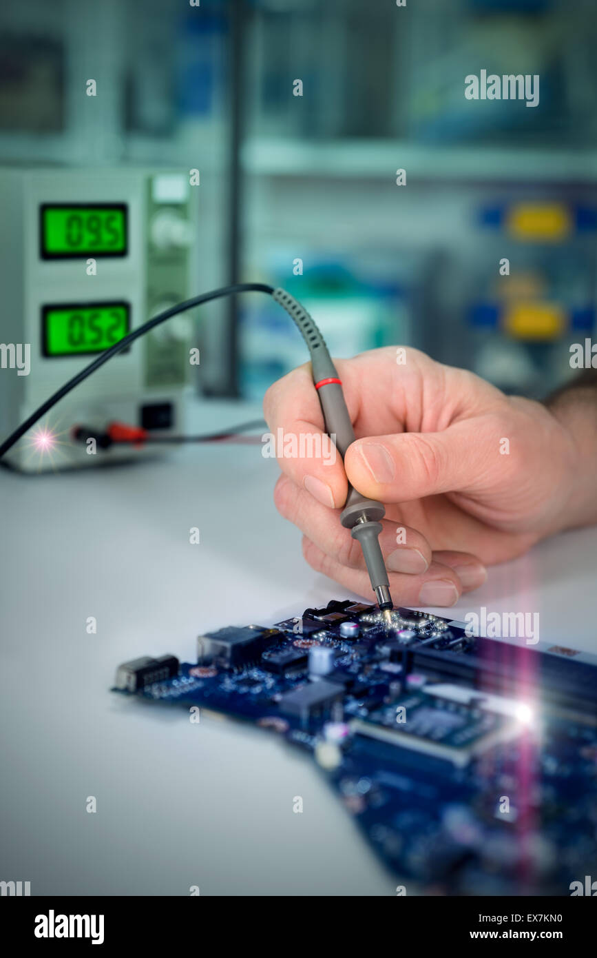 Electronic background, closeup on hands of tech fixing motherboard ...