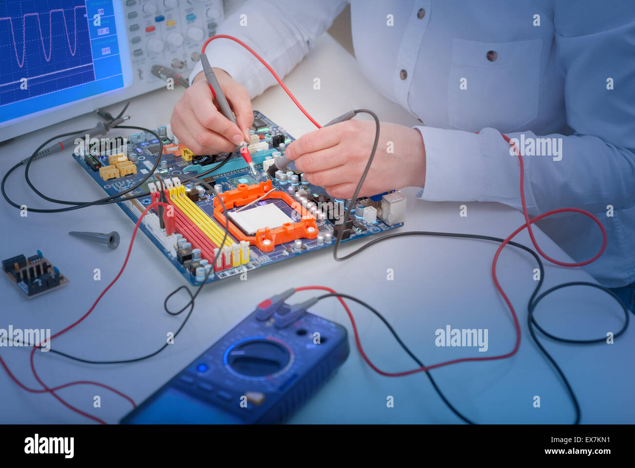 Technological background with closeup on tester checking motherboard ...