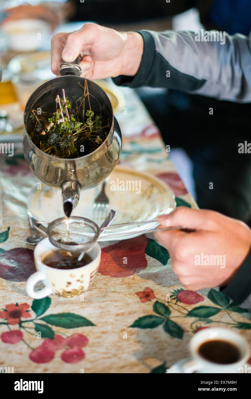 Image of person pouring a natural tea Stock Photo - Alamy
