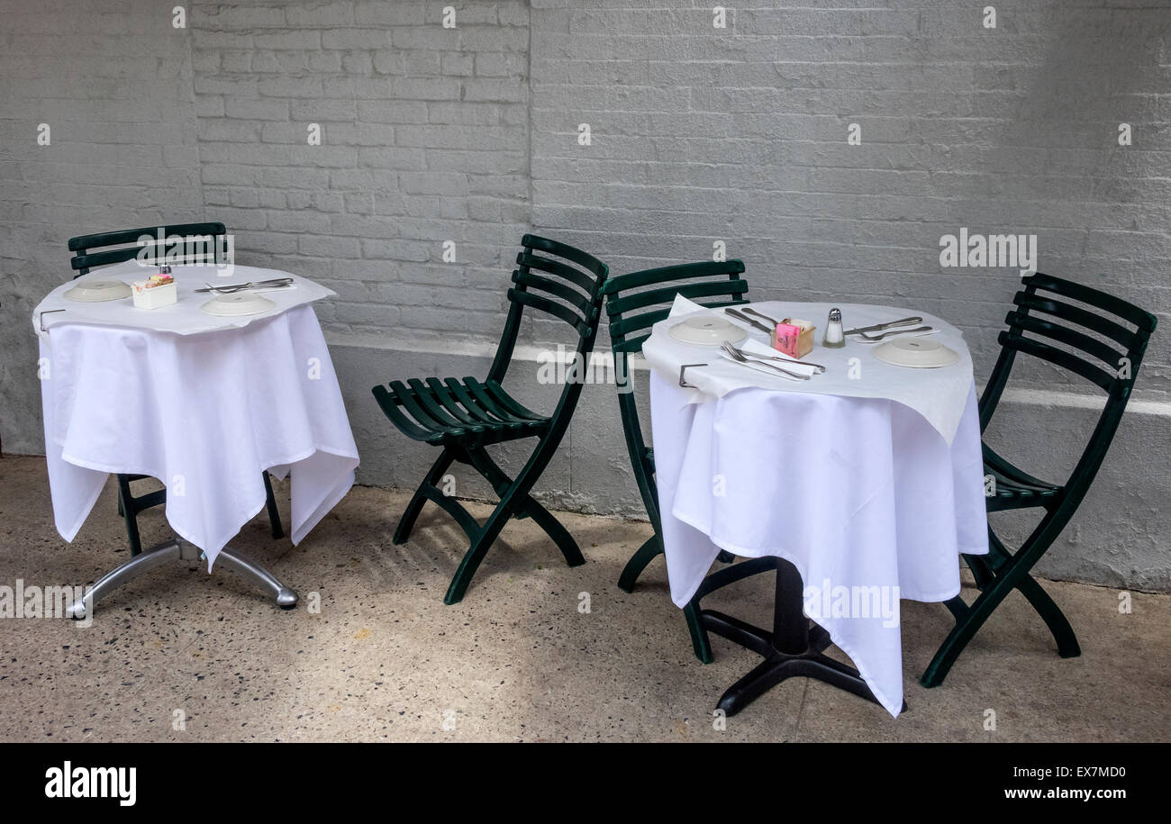 two small tables alfresco on the street outside a Soho restaurant in ...