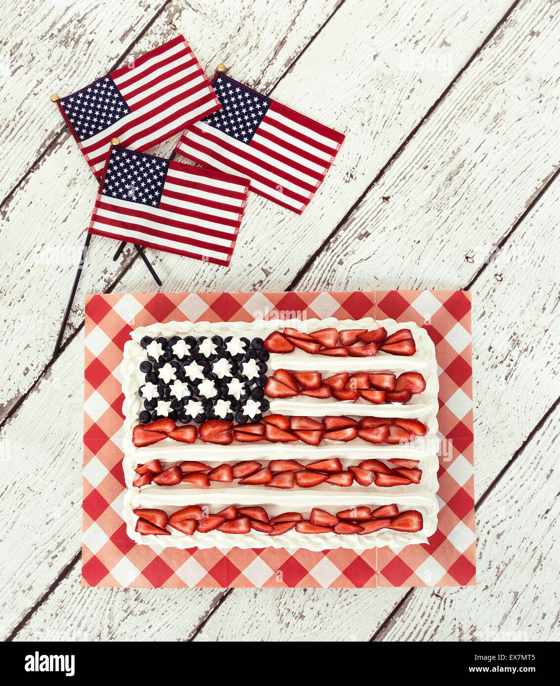 Patriotic American flag cake and decorative mini flags on vintage ...
