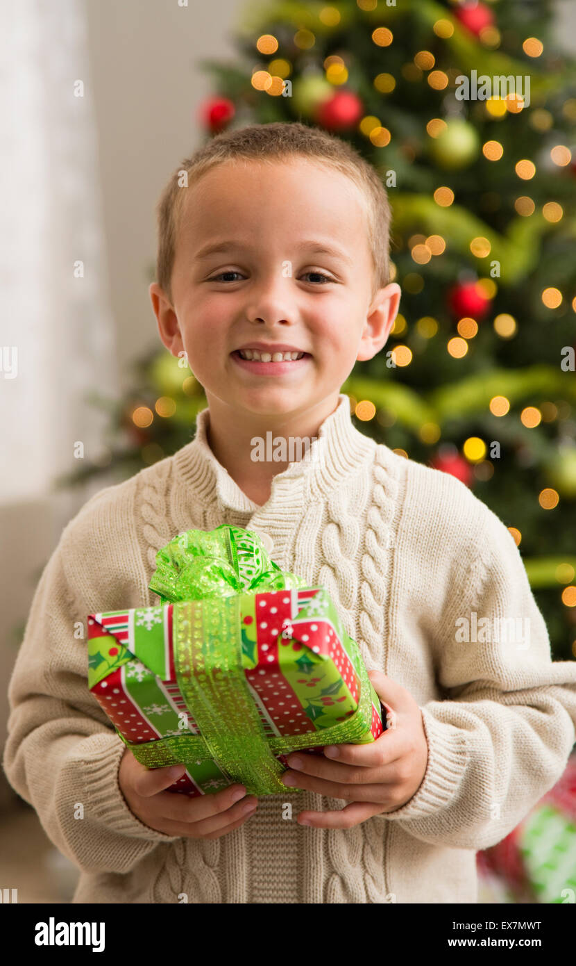 Boy holding present hi-res stock photography and images - Alamy
