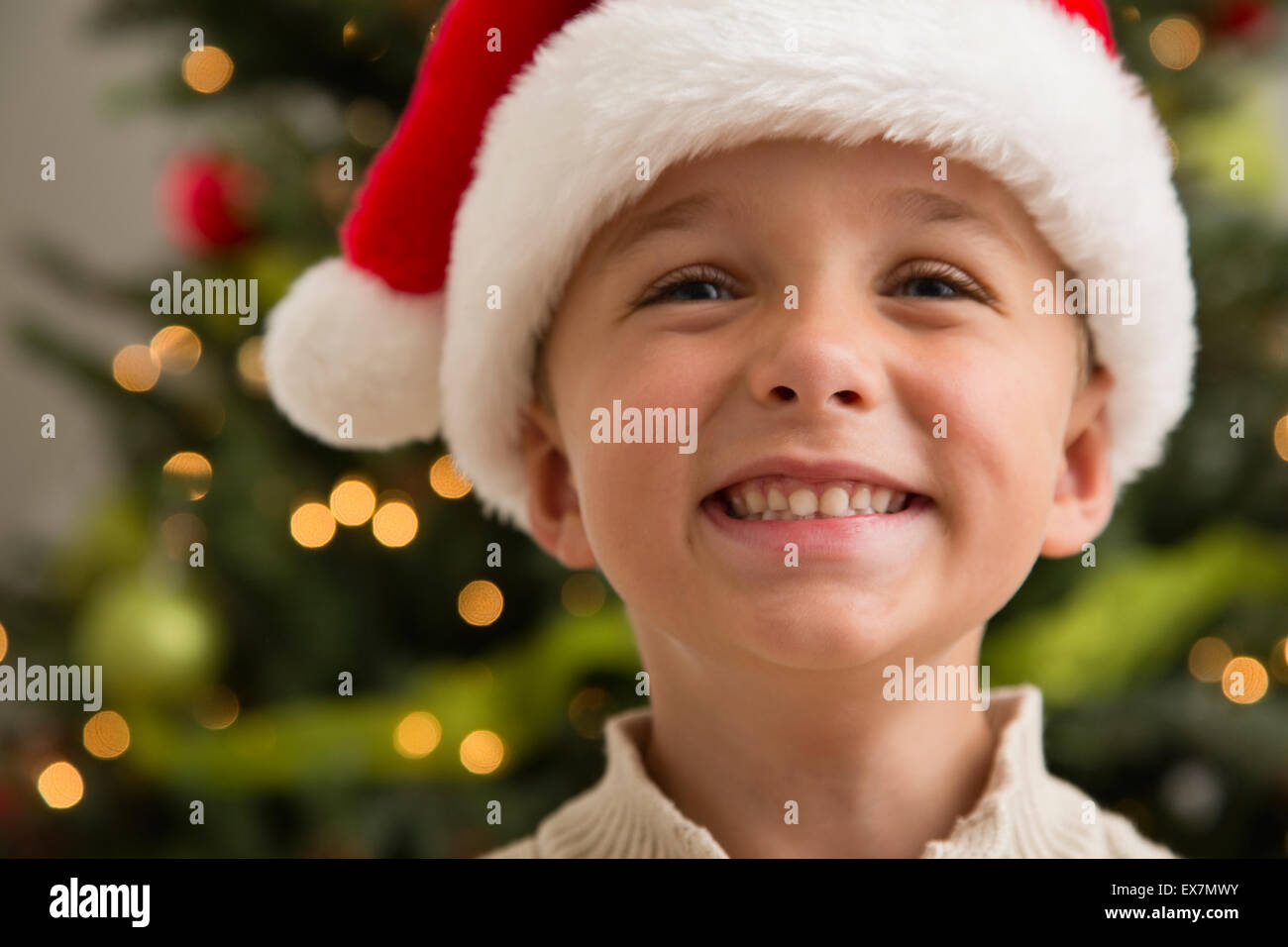 Smiling boy (6-7) wearing Santa hat Stock Photo - Alamy