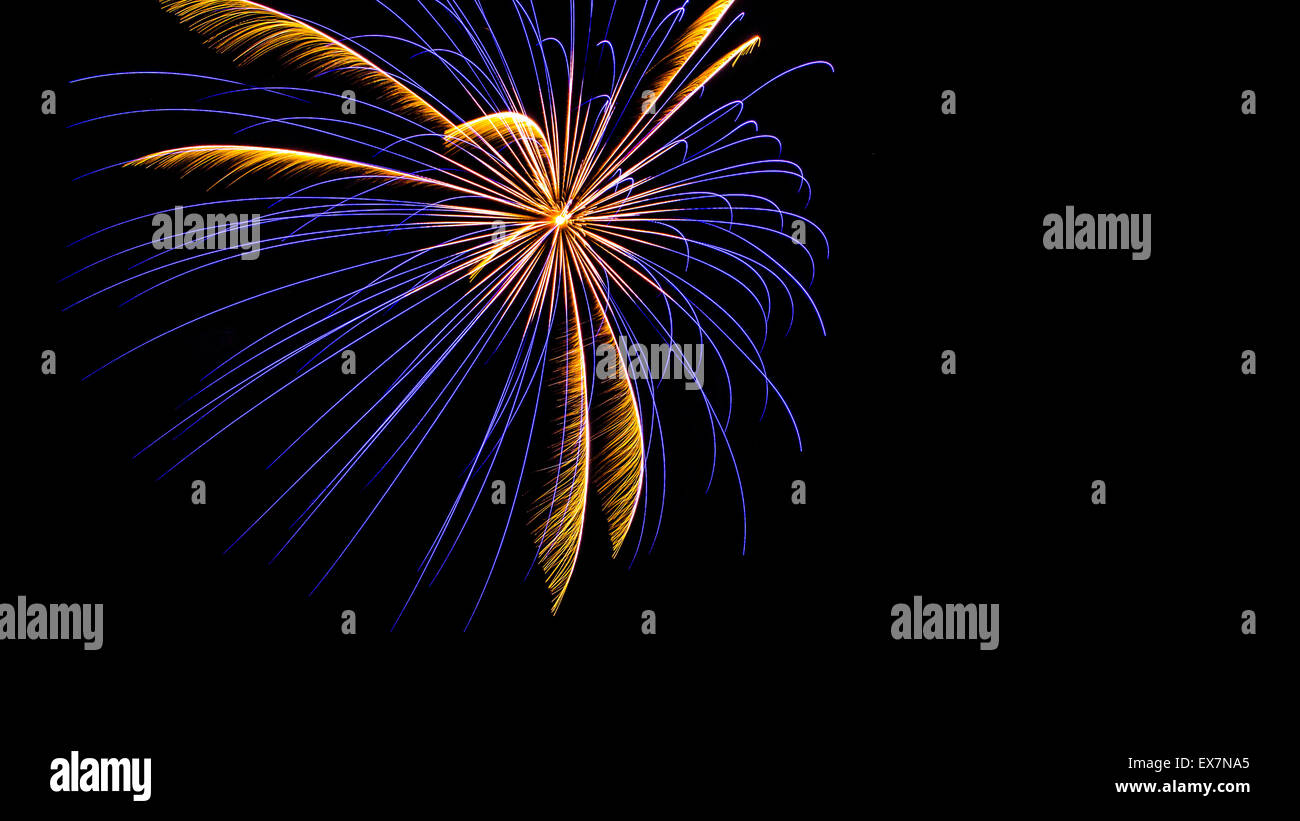 Gold and blue firework exploding at night Stock Photo - Alamy