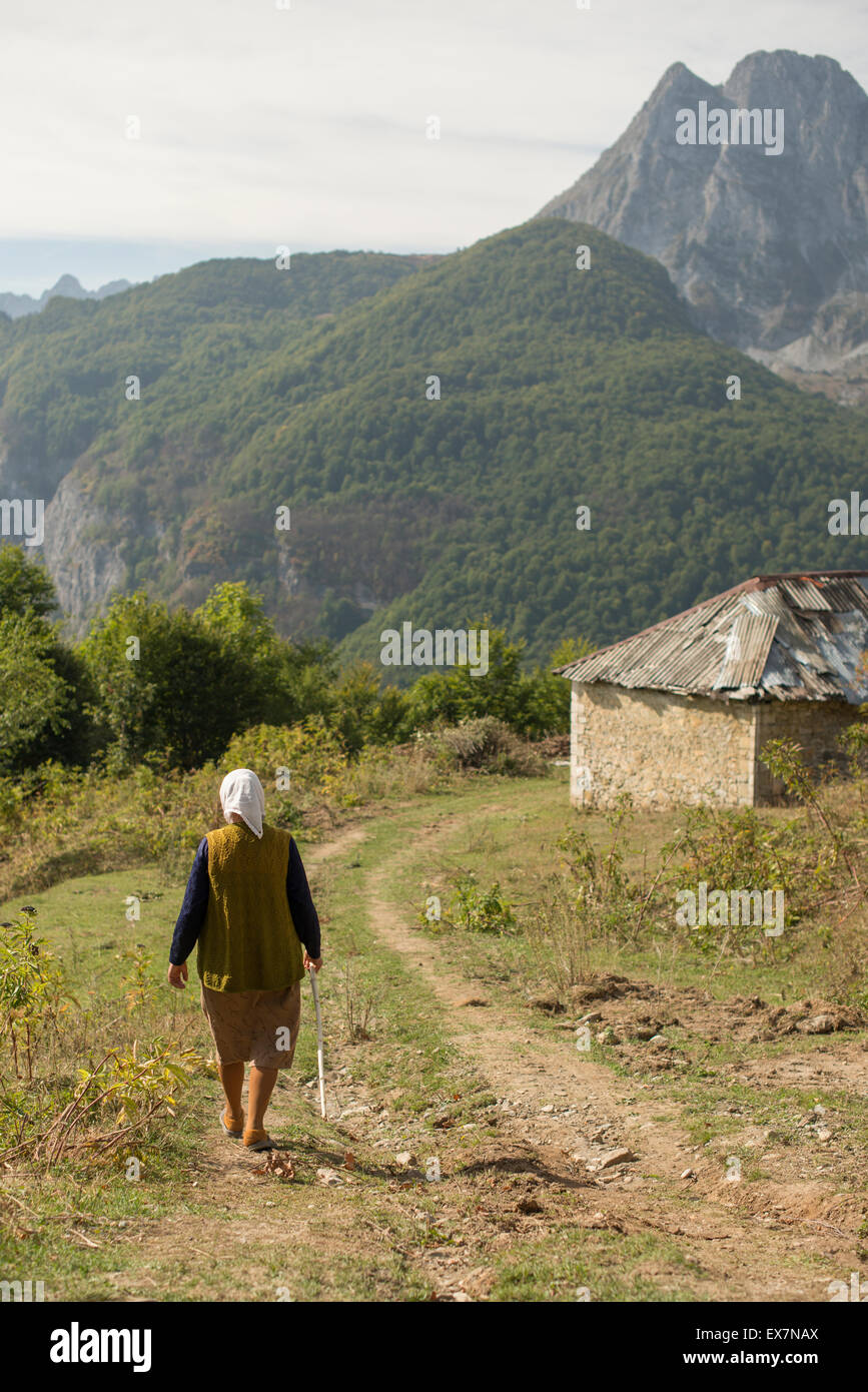 Peaks of the Balkans. Native Albanian woman walking down trail Stock ...