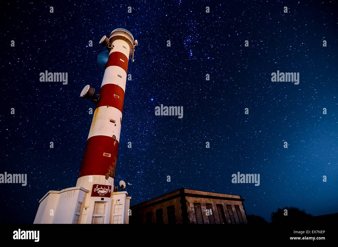 High Lighthouse near the Coast Stock Photo - Alamy