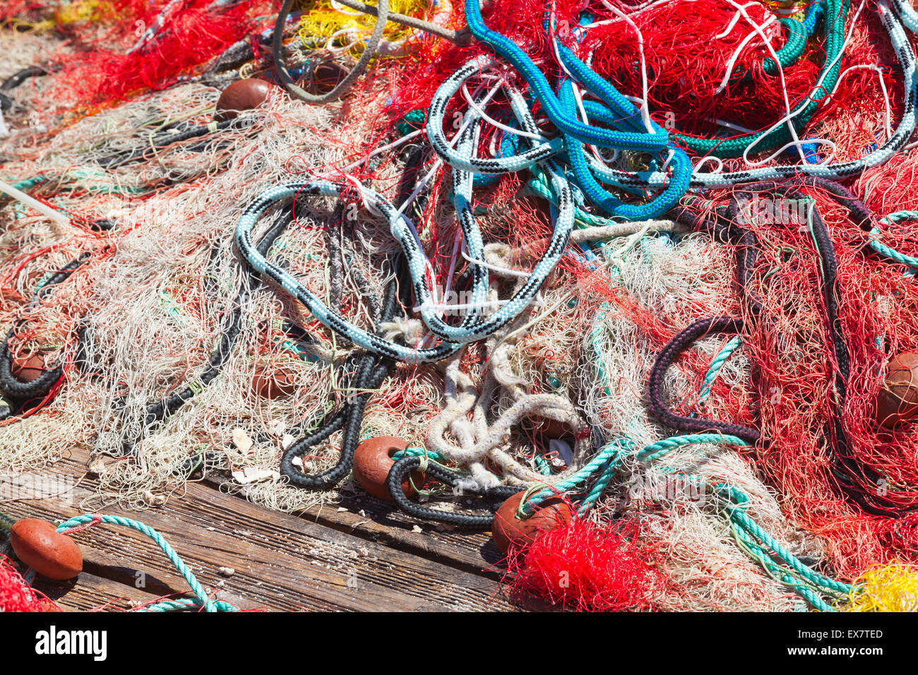 Colorful fishing net laying on a wooden pier Stock Photo - Alamy