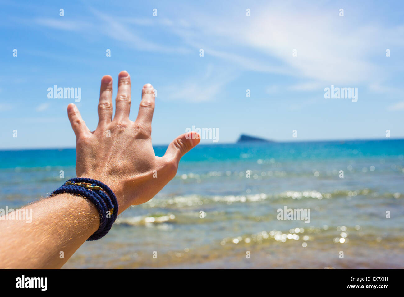 Closeup picture of mans hand on sea background Stock Photo - Alamy