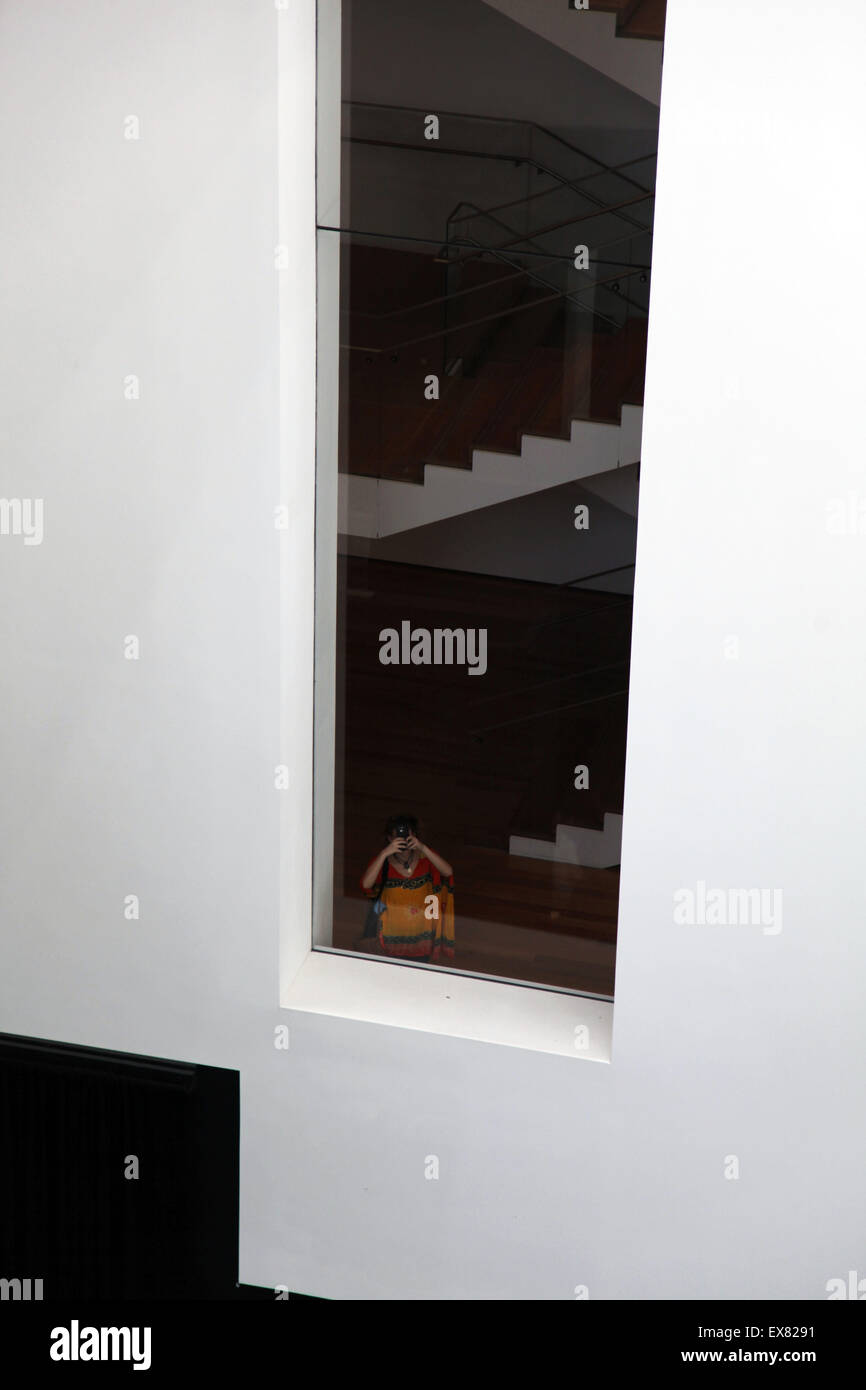 It's a photo of Somebody spying at us from behind a glass window of the ...