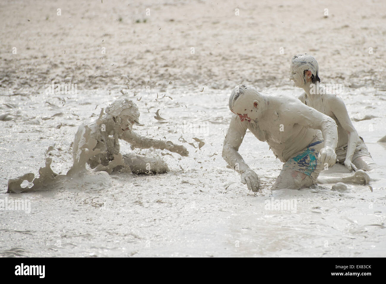 People enjoy hot weather and bathe in the mud pool with kaolin in ...