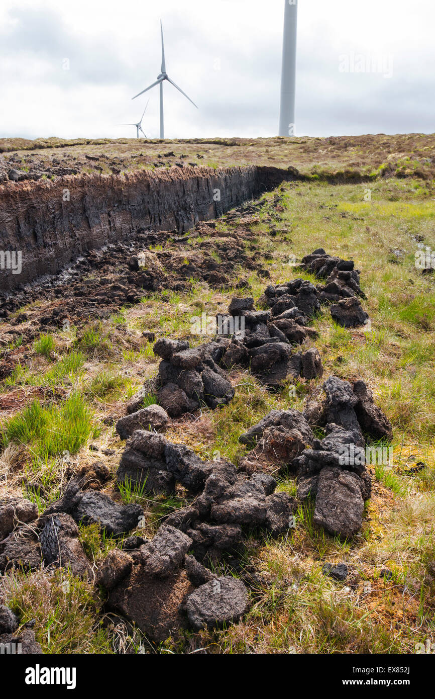 Wind turbines contrasting with peat cutting for fuel on the Isle of ...