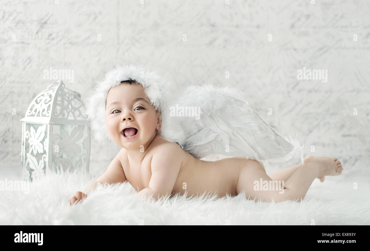 Portrait of a small cute angel Stock Photo - Alamy