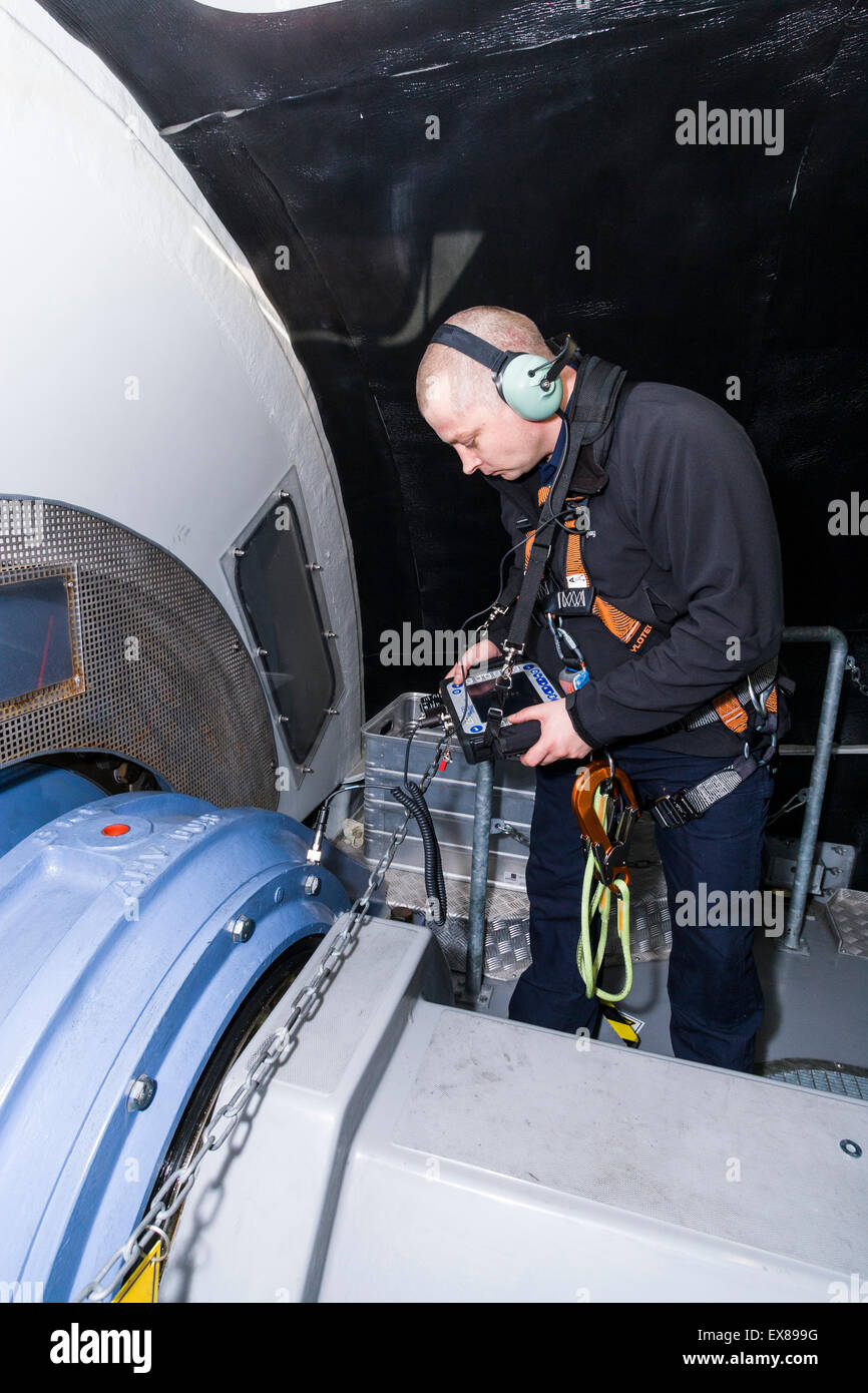 Engineer servicing a wind turbine at the Caton Moor wind farm owned by ...
