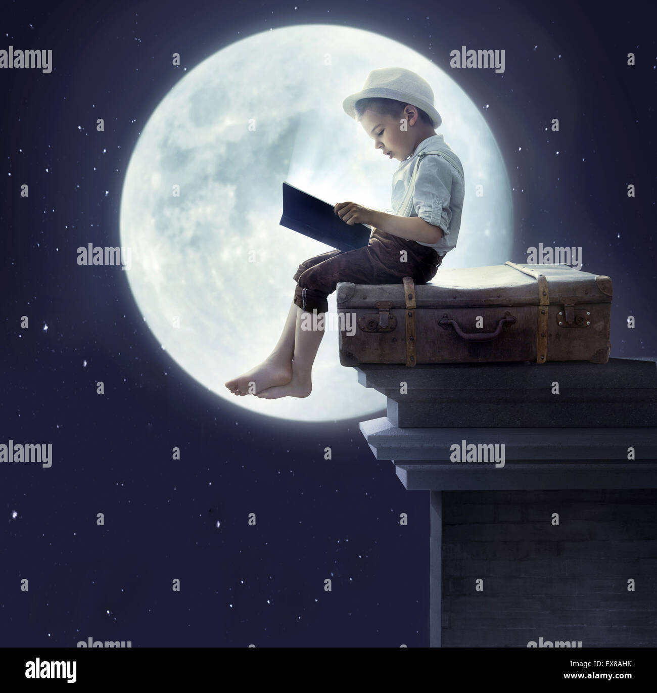 Portrait of a little boy reading a fairy tale Stock Photo - Alamy