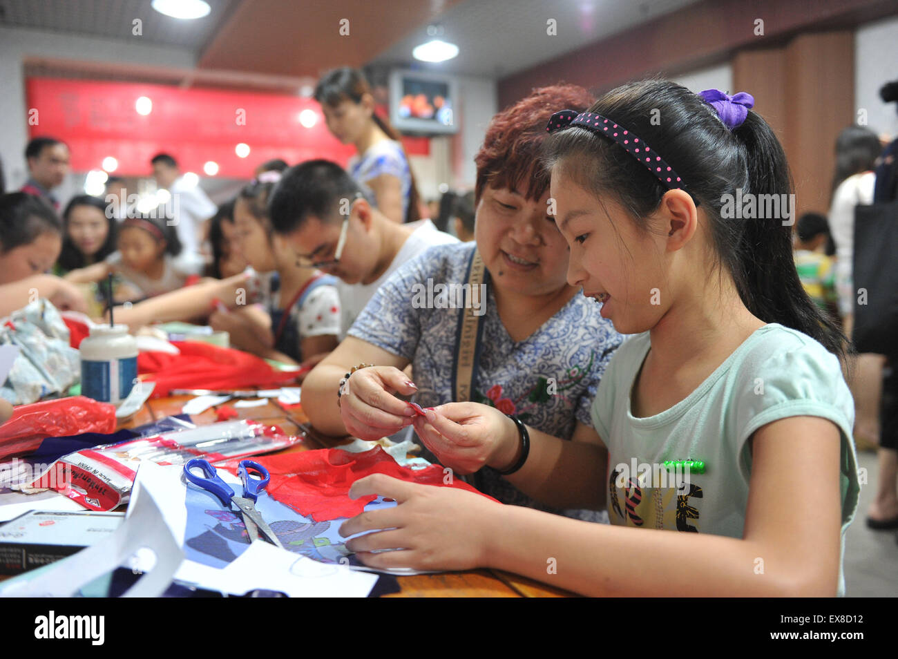 Chongqing, China. 9th July, 2015. A girl makes handicraft when cooling ...