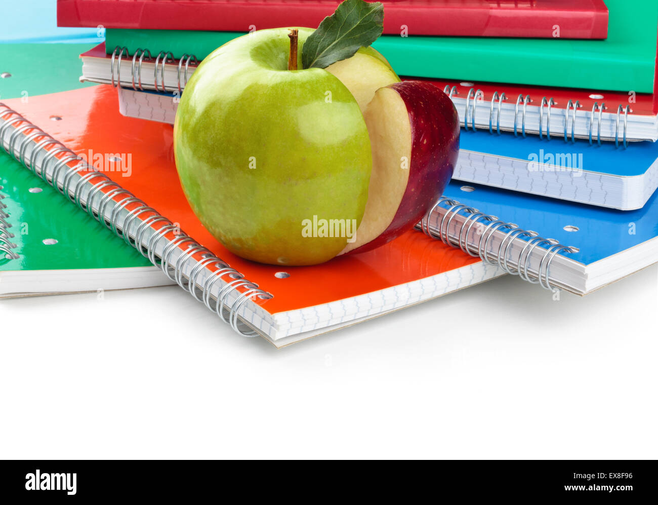 School supplies and green apple in foreground Stock Photo - Alamy