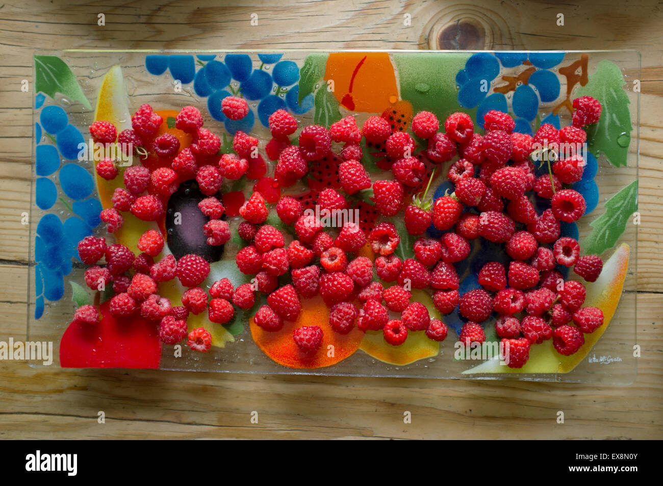 Freshly picked raspberries on a glass dish Stock Photo - Alamy