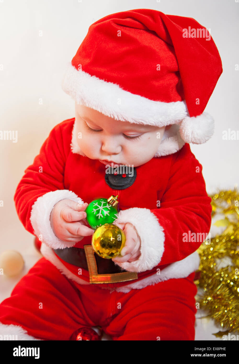 Cute baby in father Christmas outfit Stock Photo - Alamy