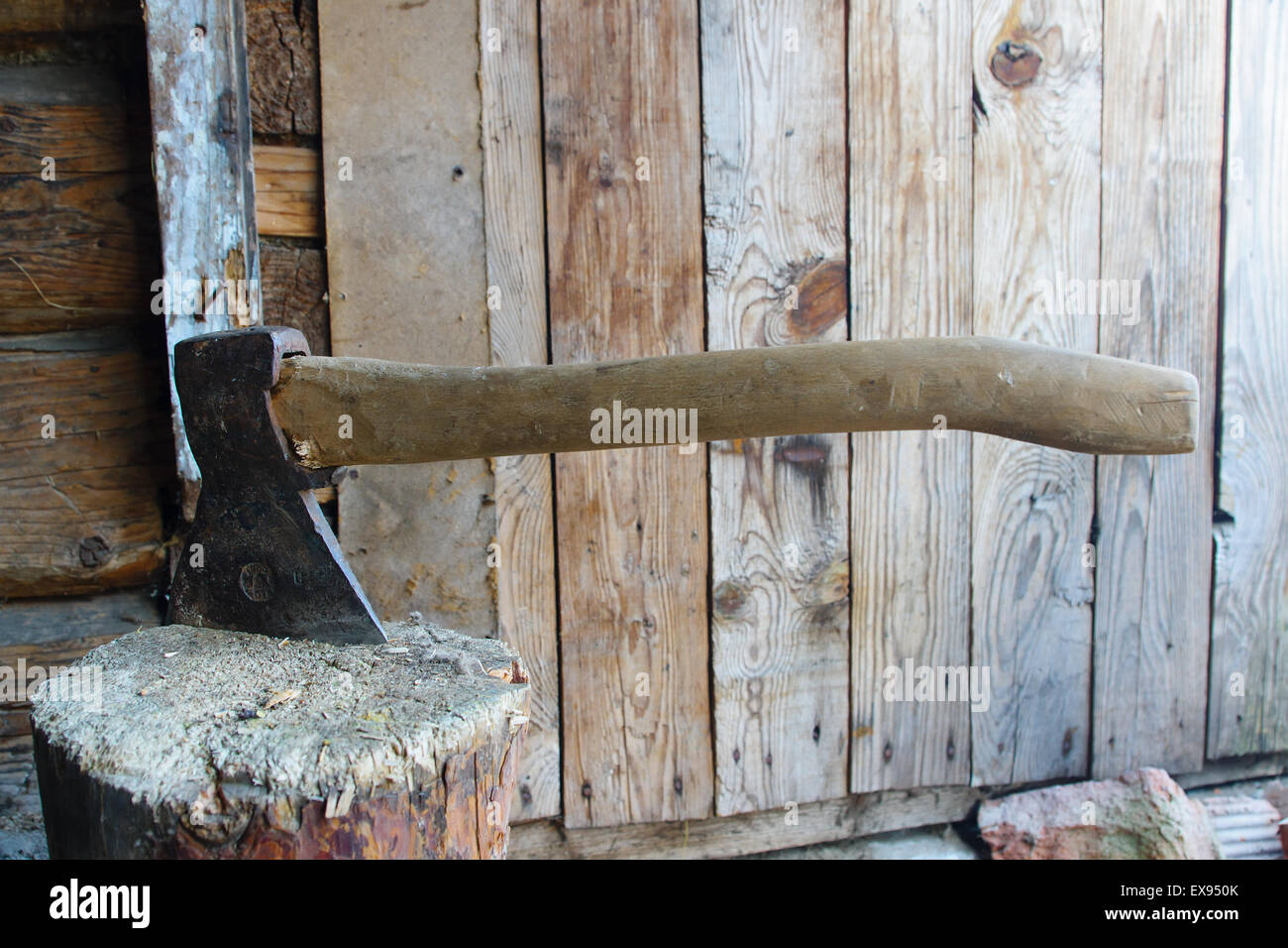 powerful axe with traces of a rust will thrust in a big wooden pack ...