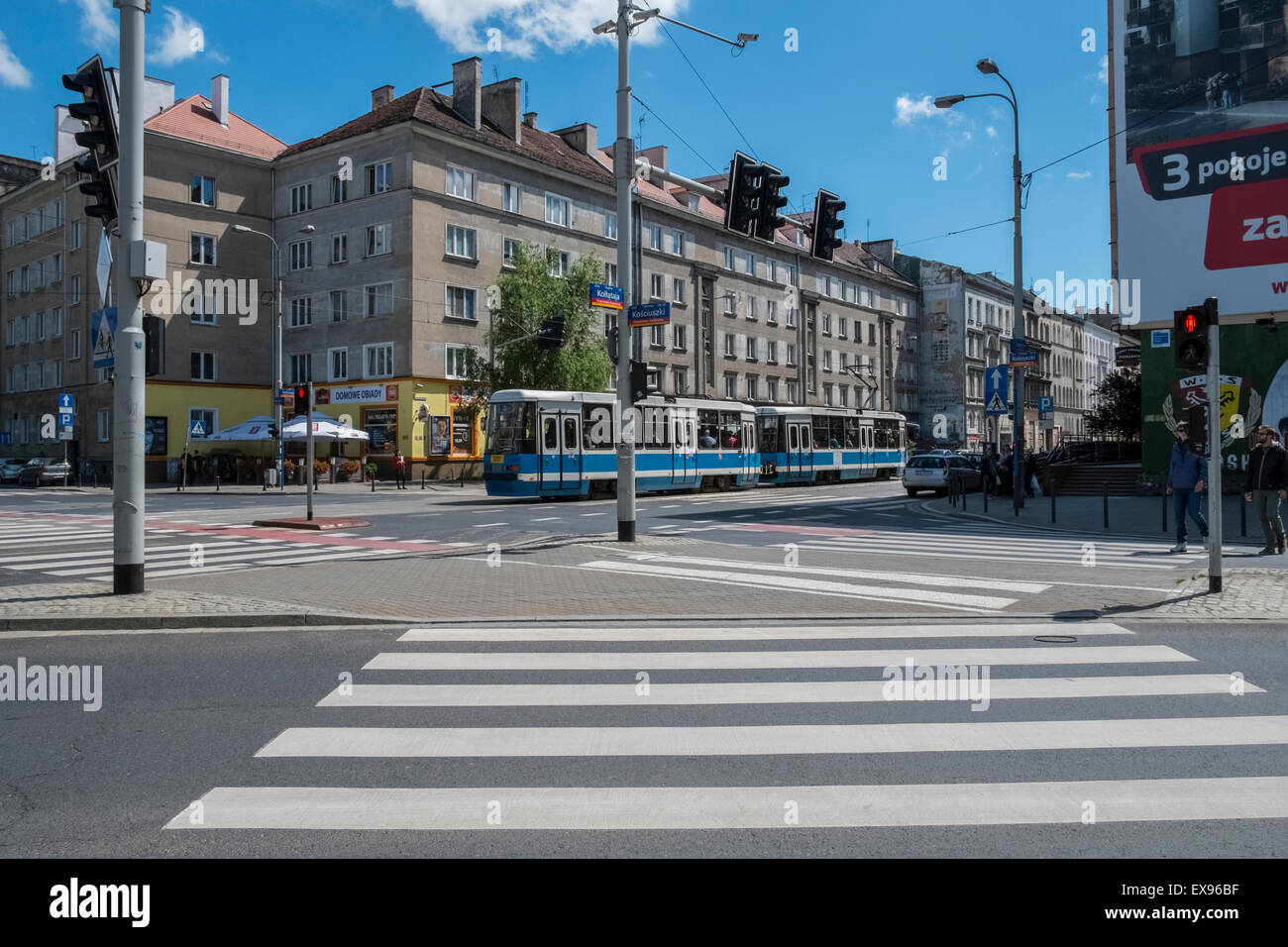Pedestrian zebra crossing at busy tram and road intersection, Wroclaw ...