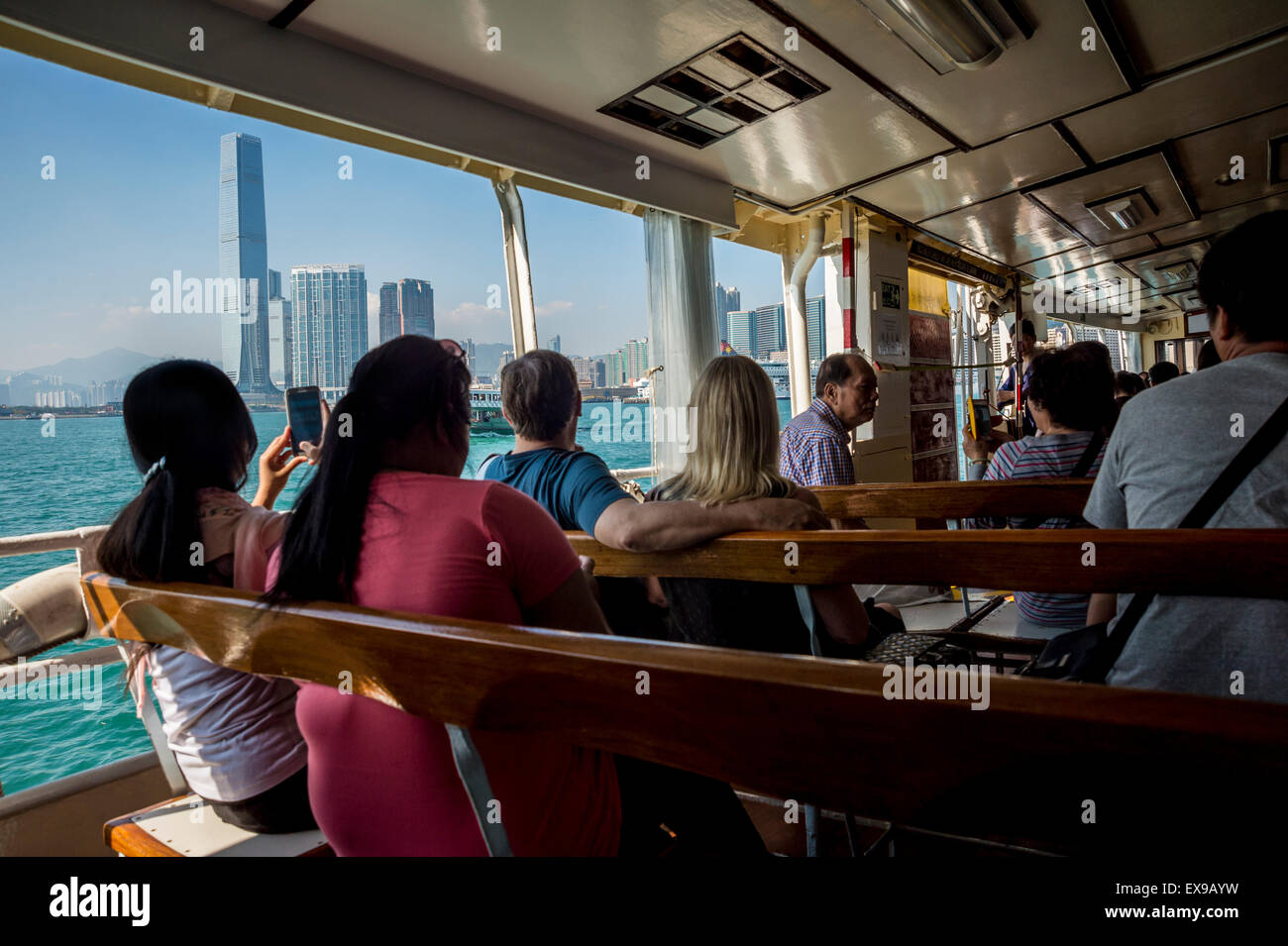 Interior of a Ferry boat in Victoria Harbor, Hong Kong, with ICC tower ...