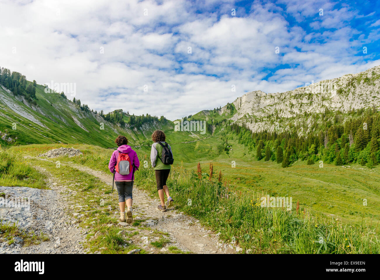 Two hikers women walking in the french Alps Stock Photo - Alamy