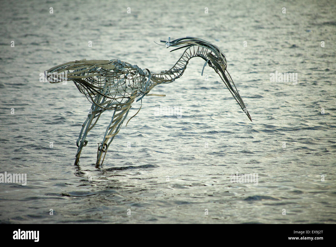 Metal heron statue situated at the edge of a reservoir in England Stock ...