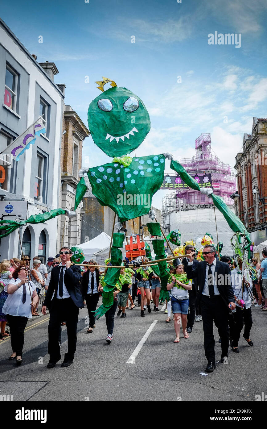 A huge effigy is paraded in one of the colourful parades on Mazey Day ...