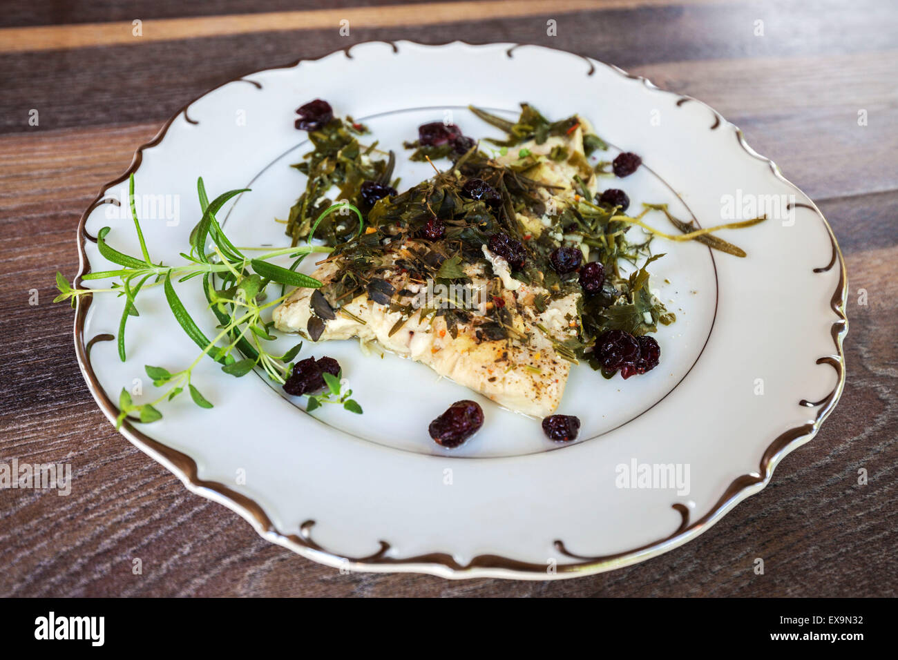 Baked cod with cranberries, thyme and rosemary Stock Photo - Alamy