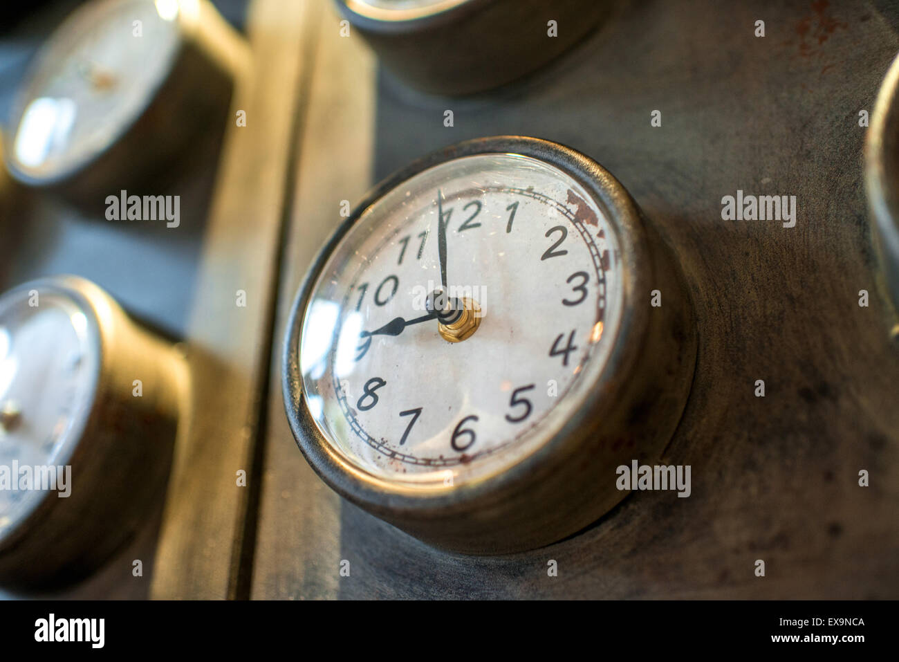 Metal rusted wall with old styled clocks and different time Stock Photo ...