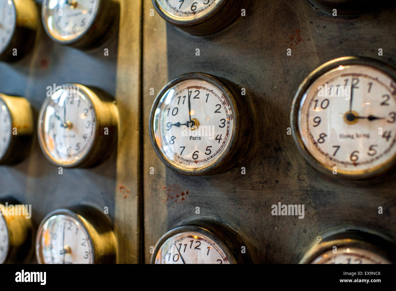 Metal rusted wall with old styled clocks and different time Stock Photo ...