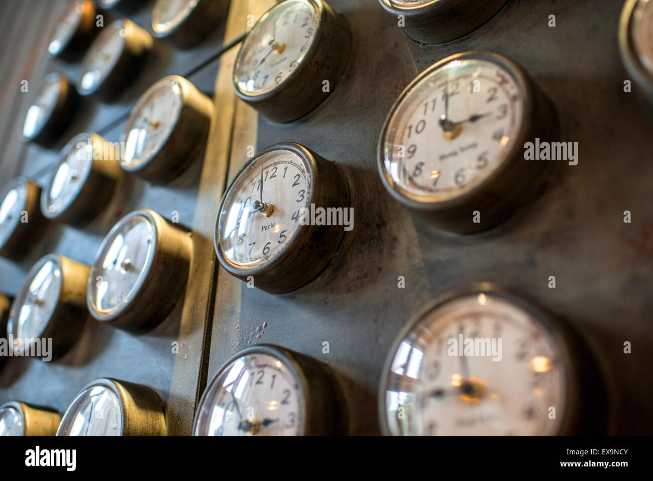 Metal rusted wall with old styled clocks and different time Stock Photo ...