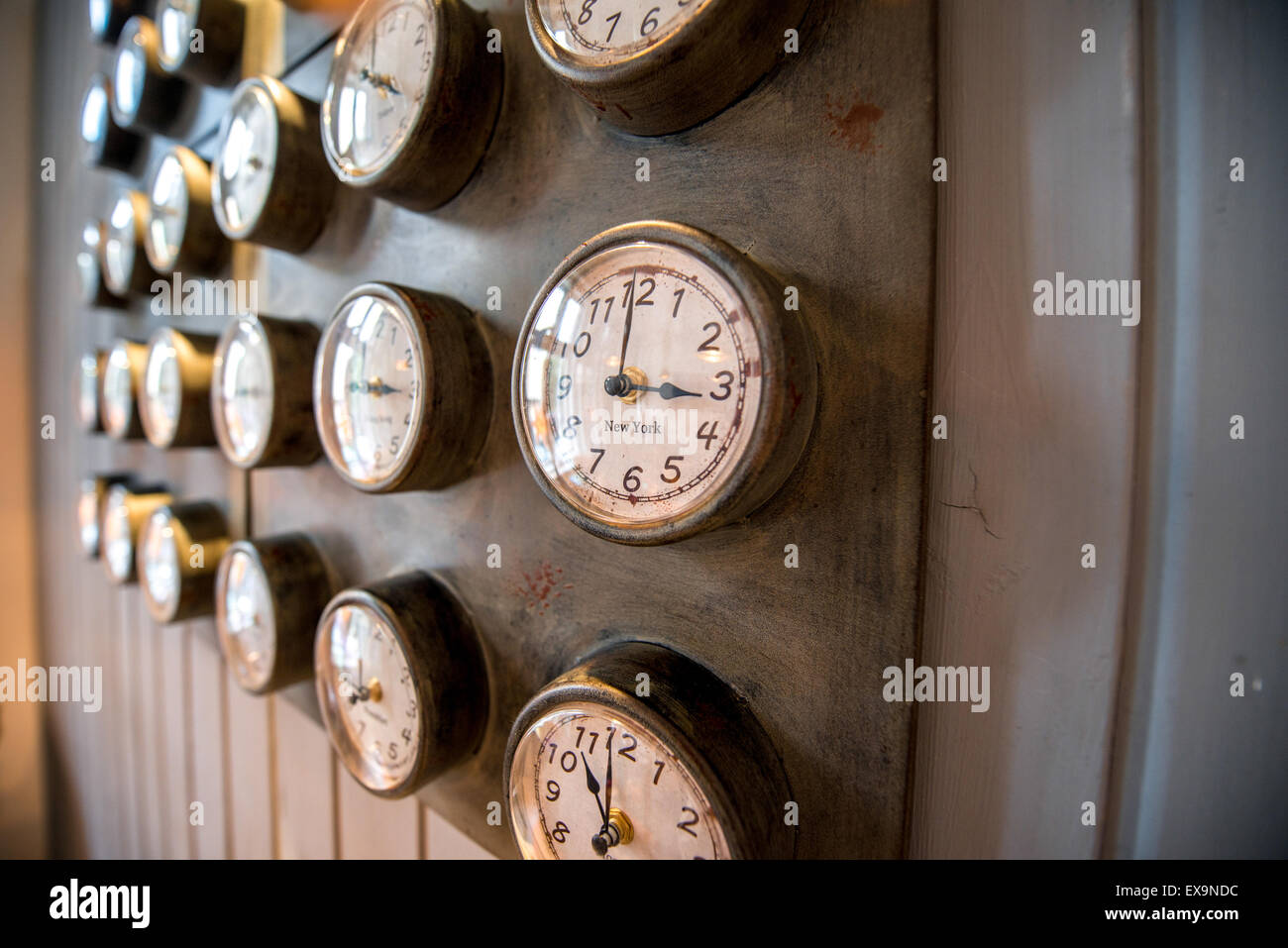 Metal rusted wall with old styled clocks and different time Stock Photo ...