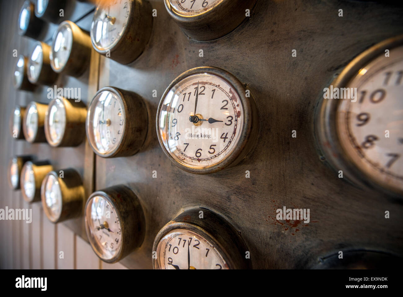 Metal rusted wall with old styled clocks and different time Stock Photo ...