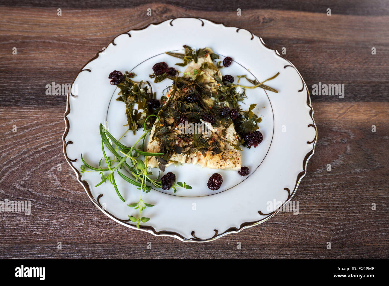 Baked cod with cranberries, thyme and rosemary Stock Photo - Alamy