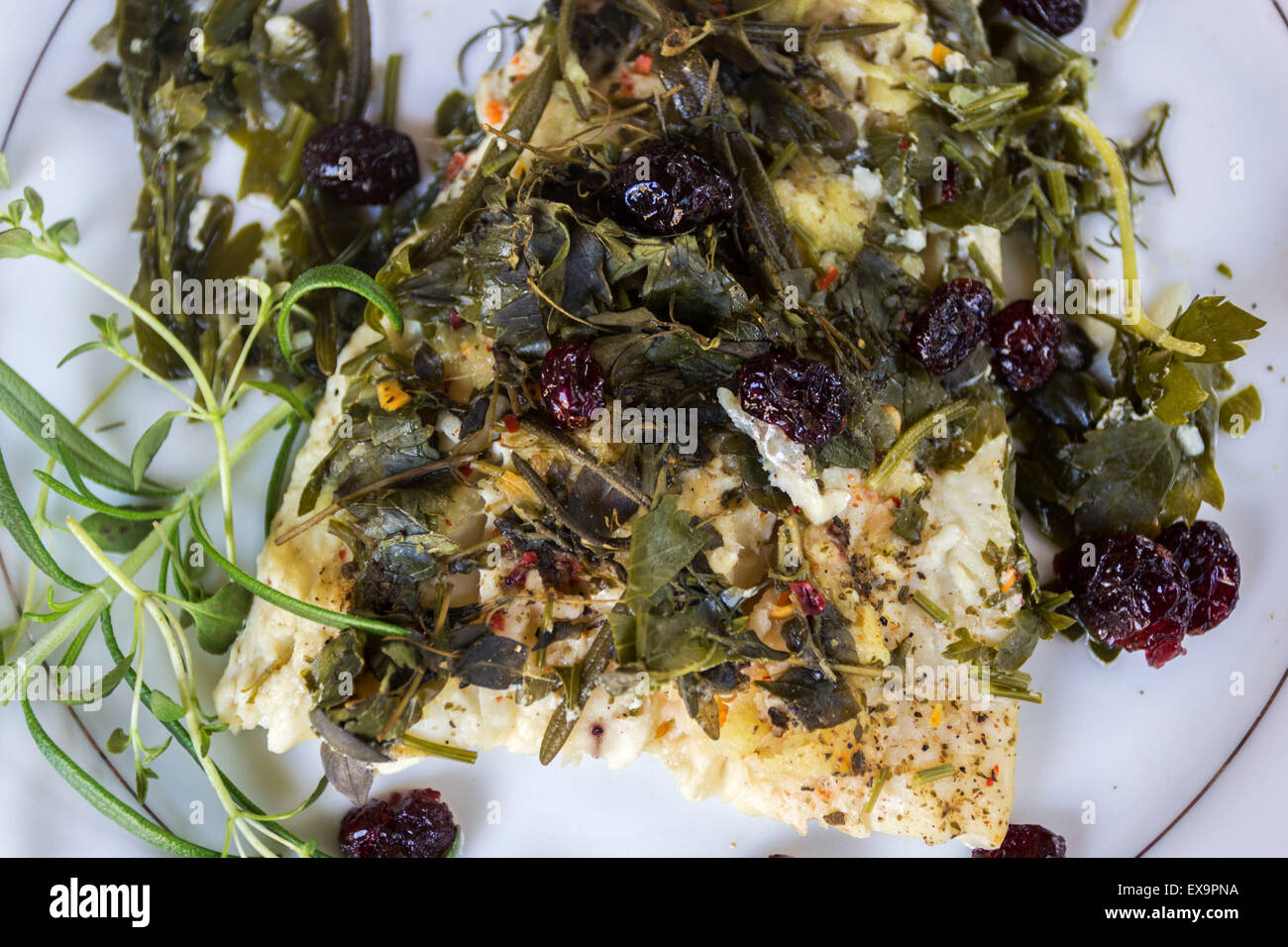 Baked cod with cranberries, thyme and rosemary Stock Photo - Alamy