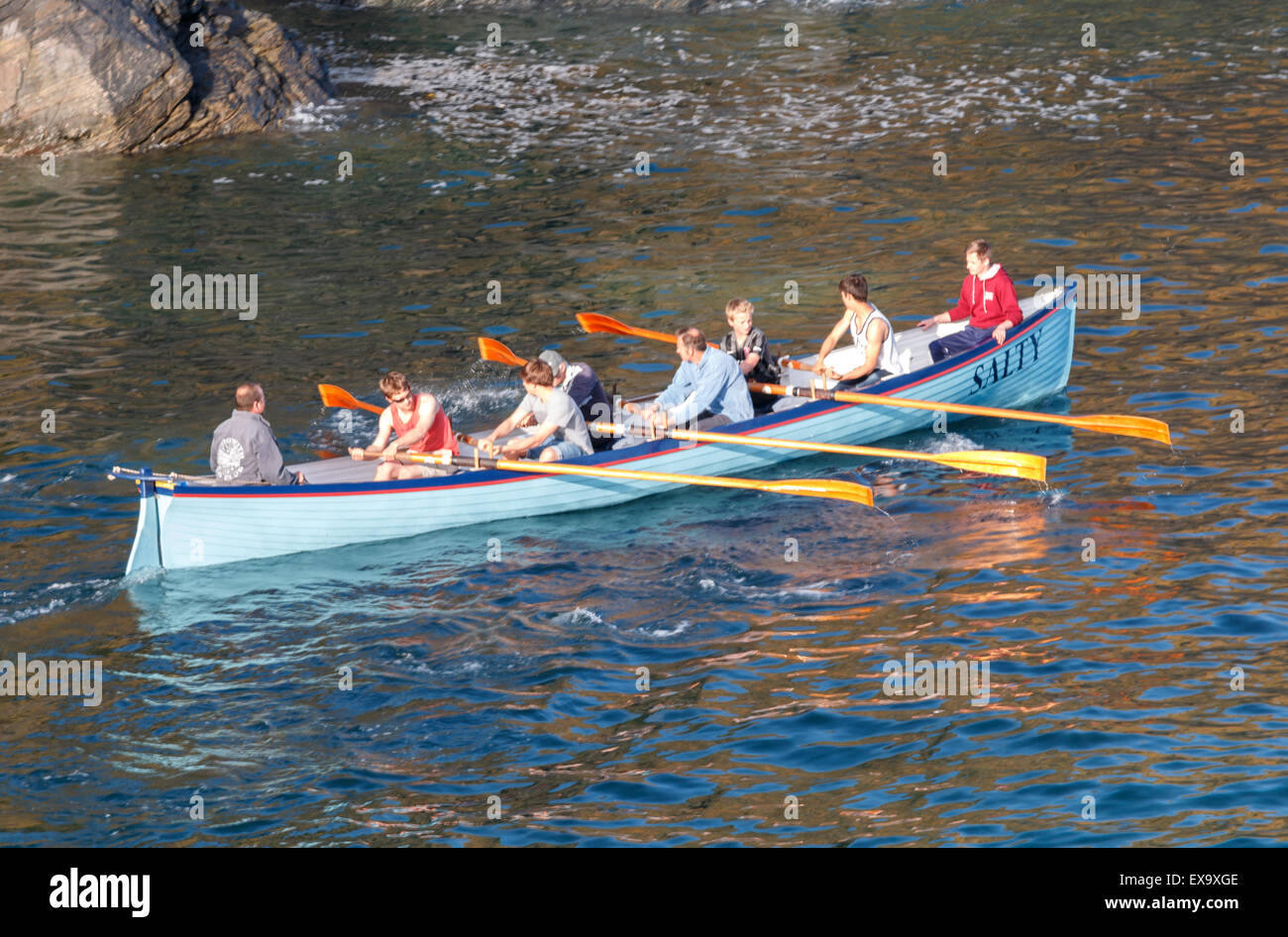 Gig racing - the rowers get the boat moving across the sea at Cadgwith ...