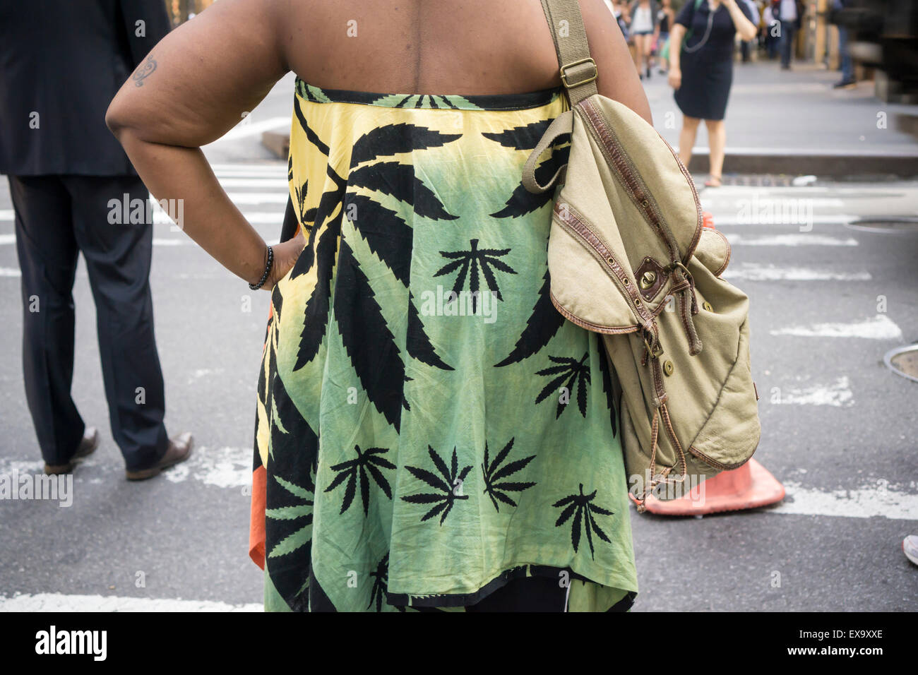 A woman waits to cross the street in Midtown Manhattan in New York ...