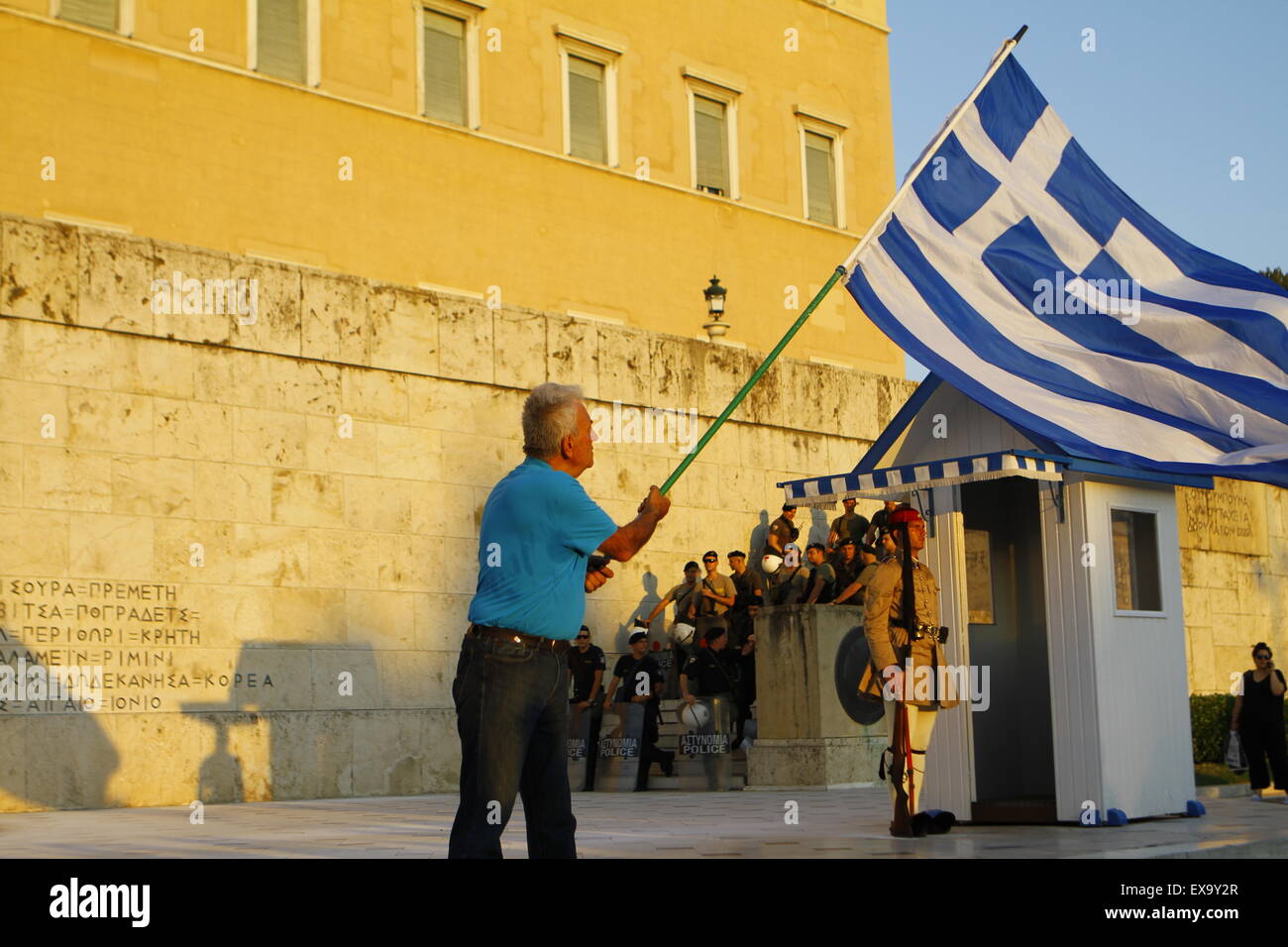 Athens, Greece. 09th July, 2015. A protester waves a large Greek flag ...