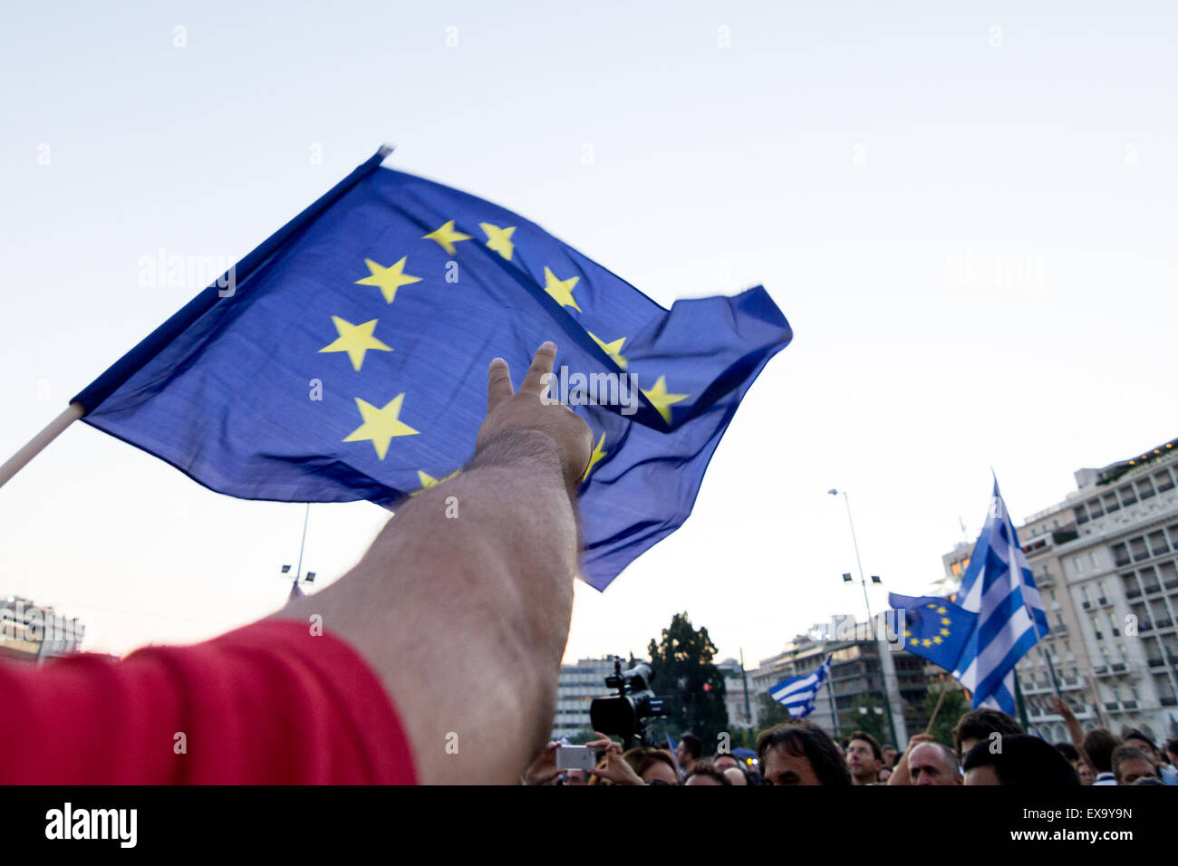 Athens, Greece. 09th July, 2015. A man forms a "victory sign" under a ...