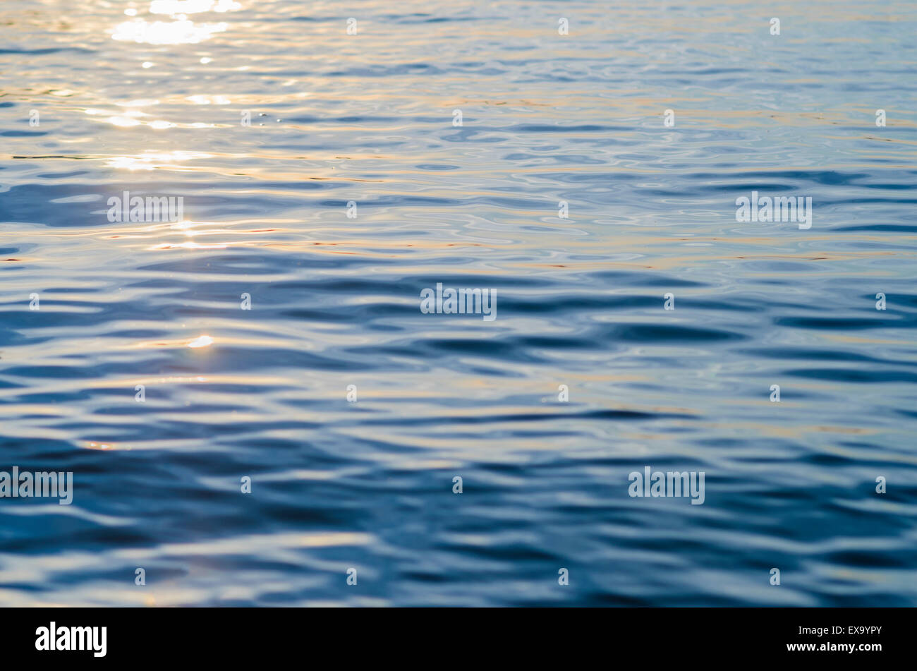 Blue Lake Texture With Yellow Sun Rays Stock Photo - Alamy
