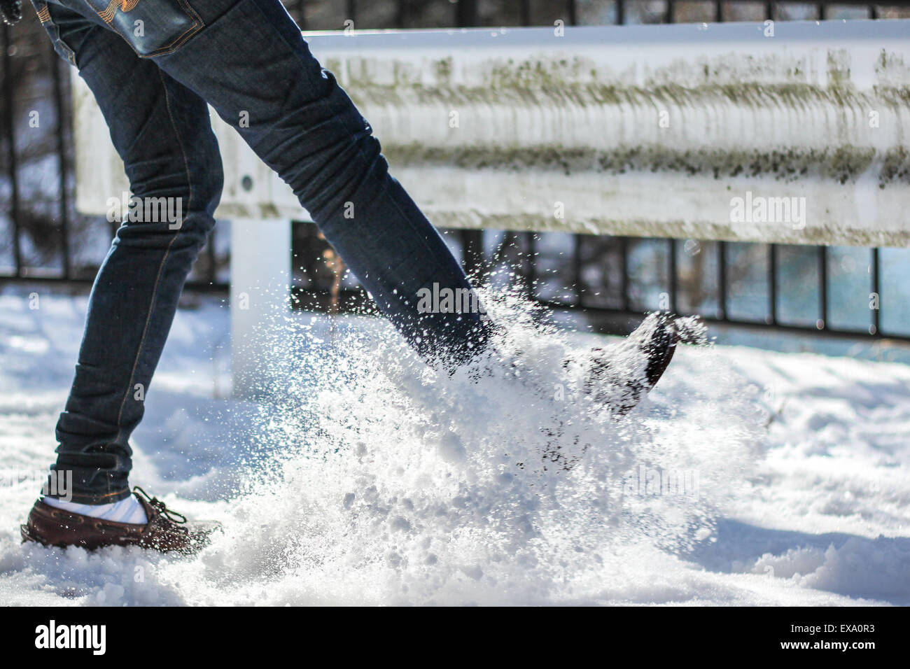 Man kicking snow Stock Photo - Alamy