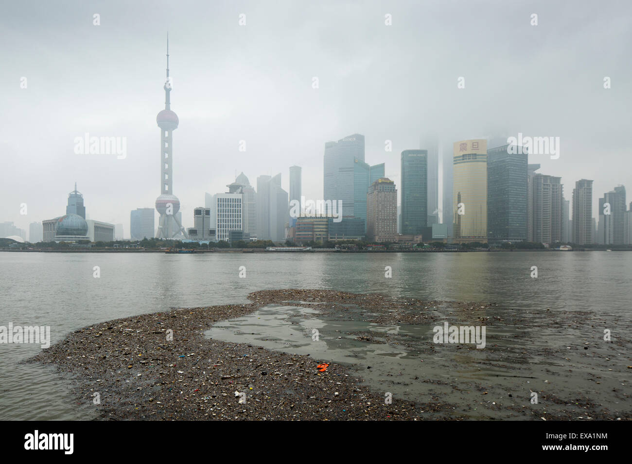 China, Shanghai, Vast pool of trash floats past skyline of Pudong ...