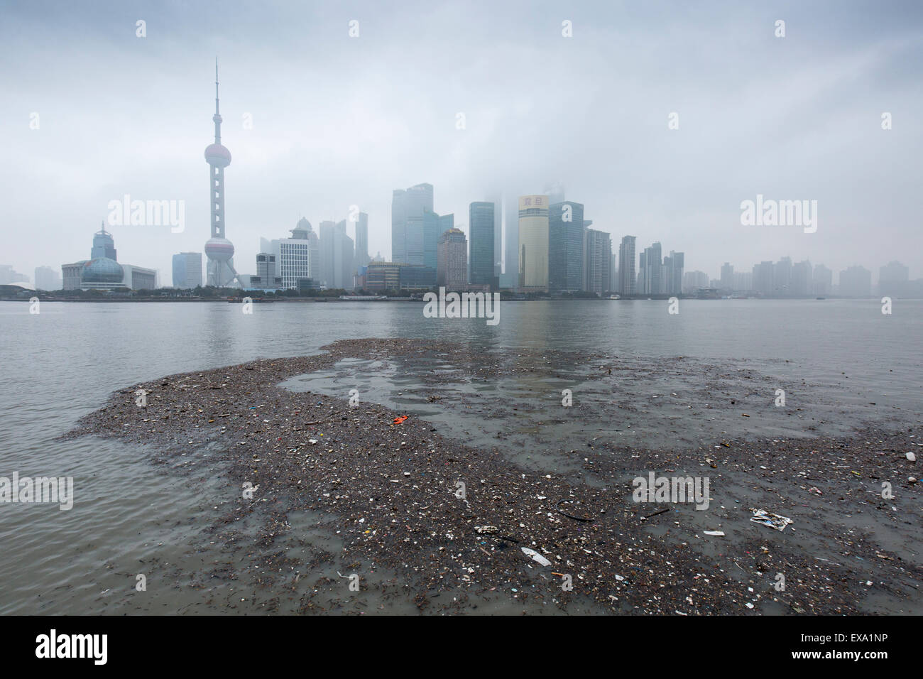 China, Shanghai, Vast pool of trash floats past skyline of Pudong ...