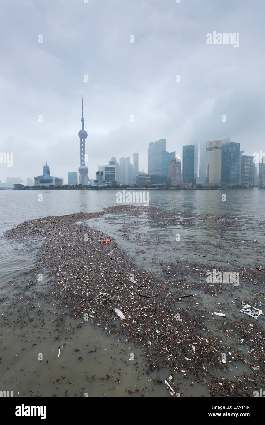 China, Shanghai, Vast pool of trash floats past skyline of Pudong ...