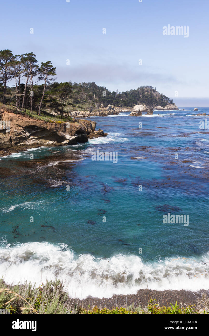 Beautiful dramatic coastline with large rocks and waves splashing in ...