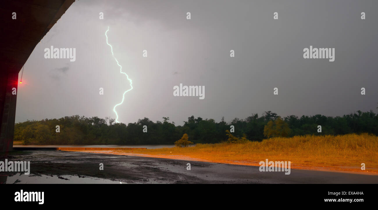 Lightning strikes outside the cover of a South Texas highway overpass ...