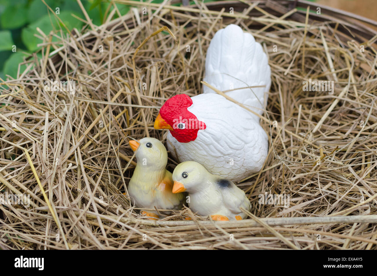 Statue of chickens on a pile of straw Stock Photo - Alamy